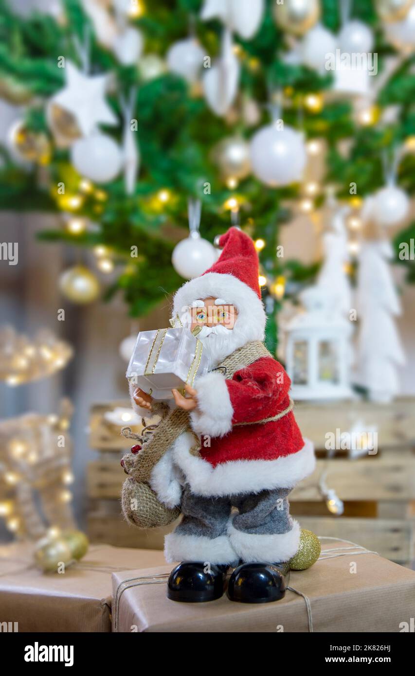 Santa claus figurine at christmas tree Stock Photo - Alamy