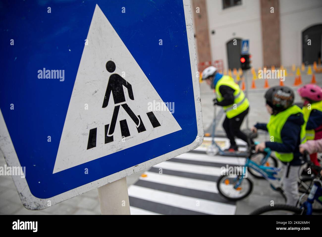 Zebra road signs many child with bicycle and roller scooter in ...