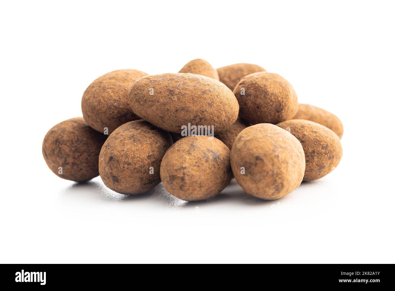 Almonds in chocolate coated in cocoa powder isolated on a white ...