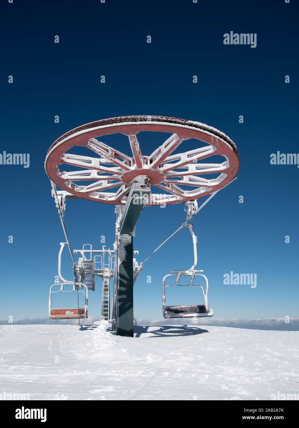 Frozen Ski lift on a snowy mountain against blue sky Stock Photo - Alamy