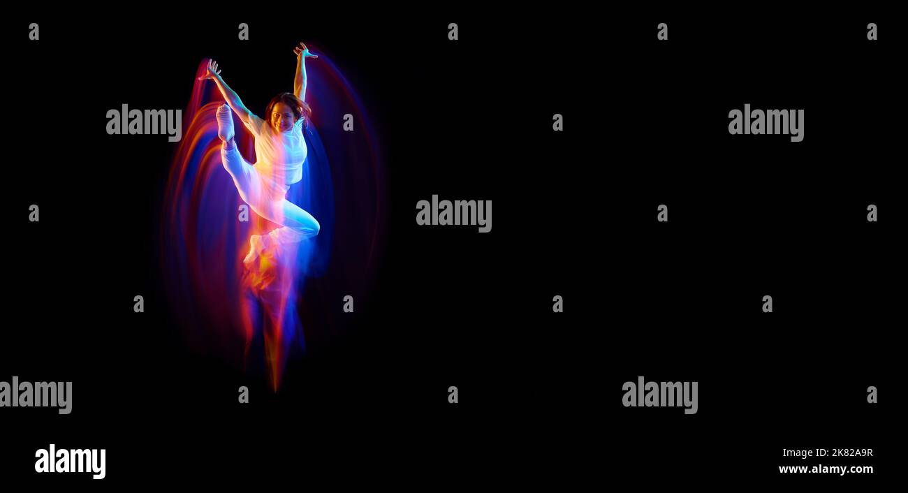 In miracle flight. Young sportive dancer in white clothes levitating ...
