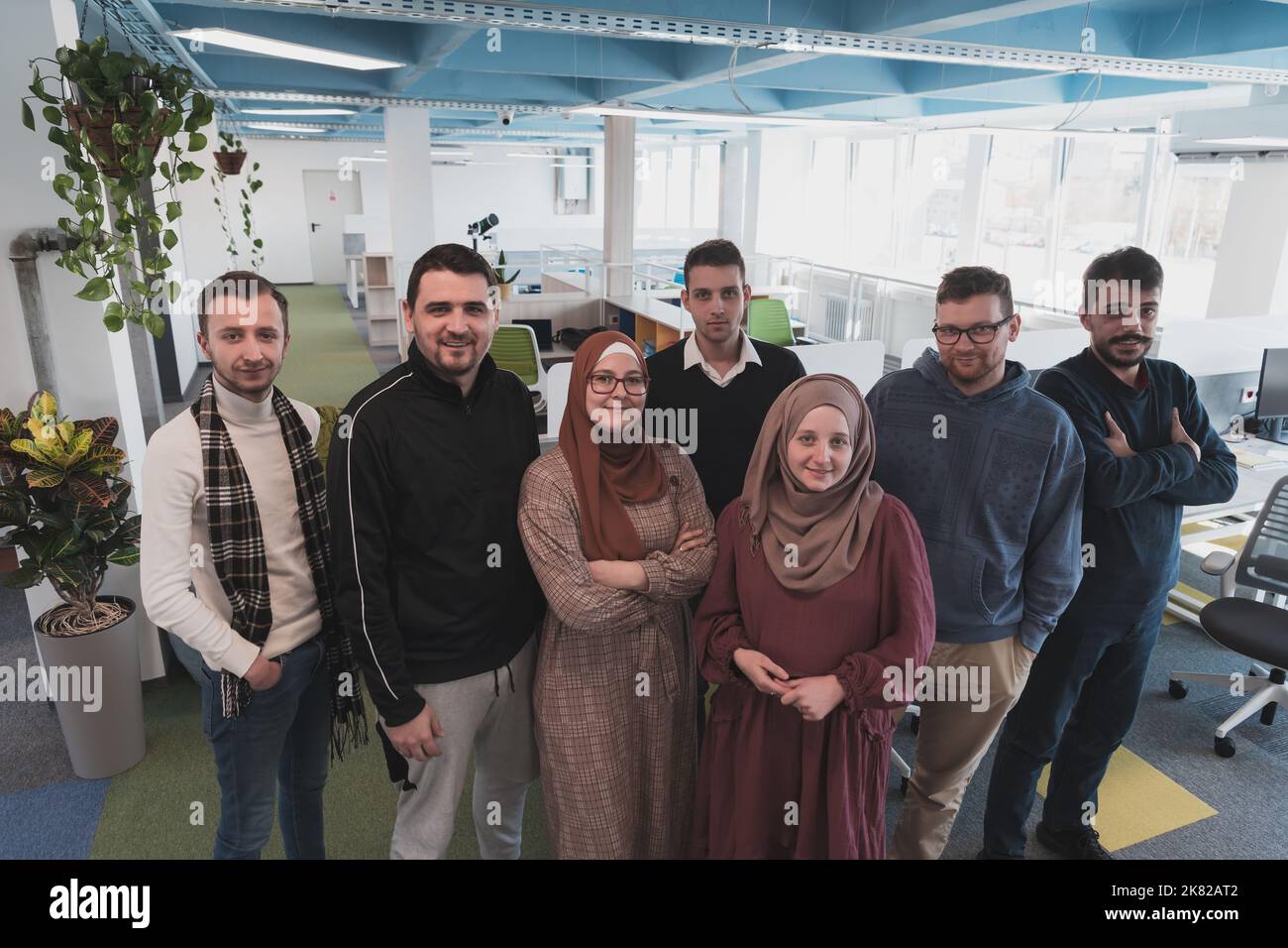 Portrait of successful creative business team looking at camera and ...