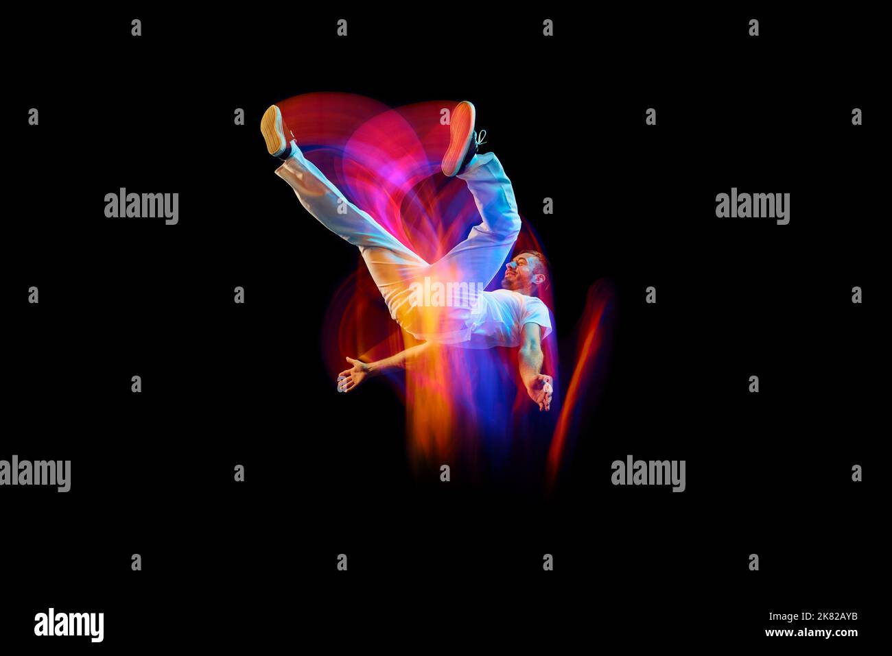 In miracle flight. Young sportive dancer in white clothes levitating ...