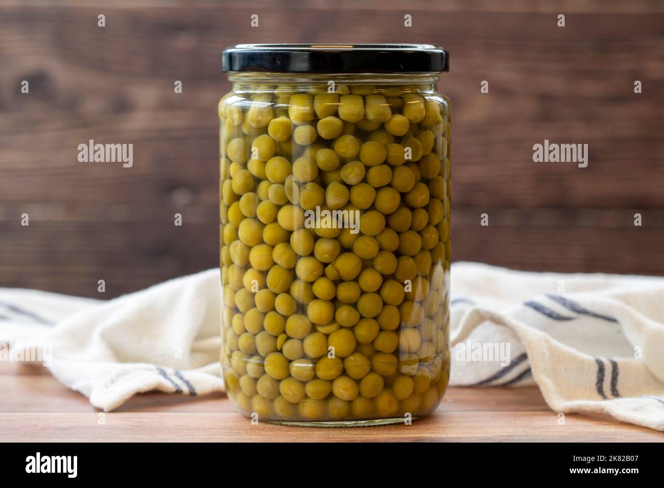 Canned peas in glass jar on wood background Stock Photo - Alamy