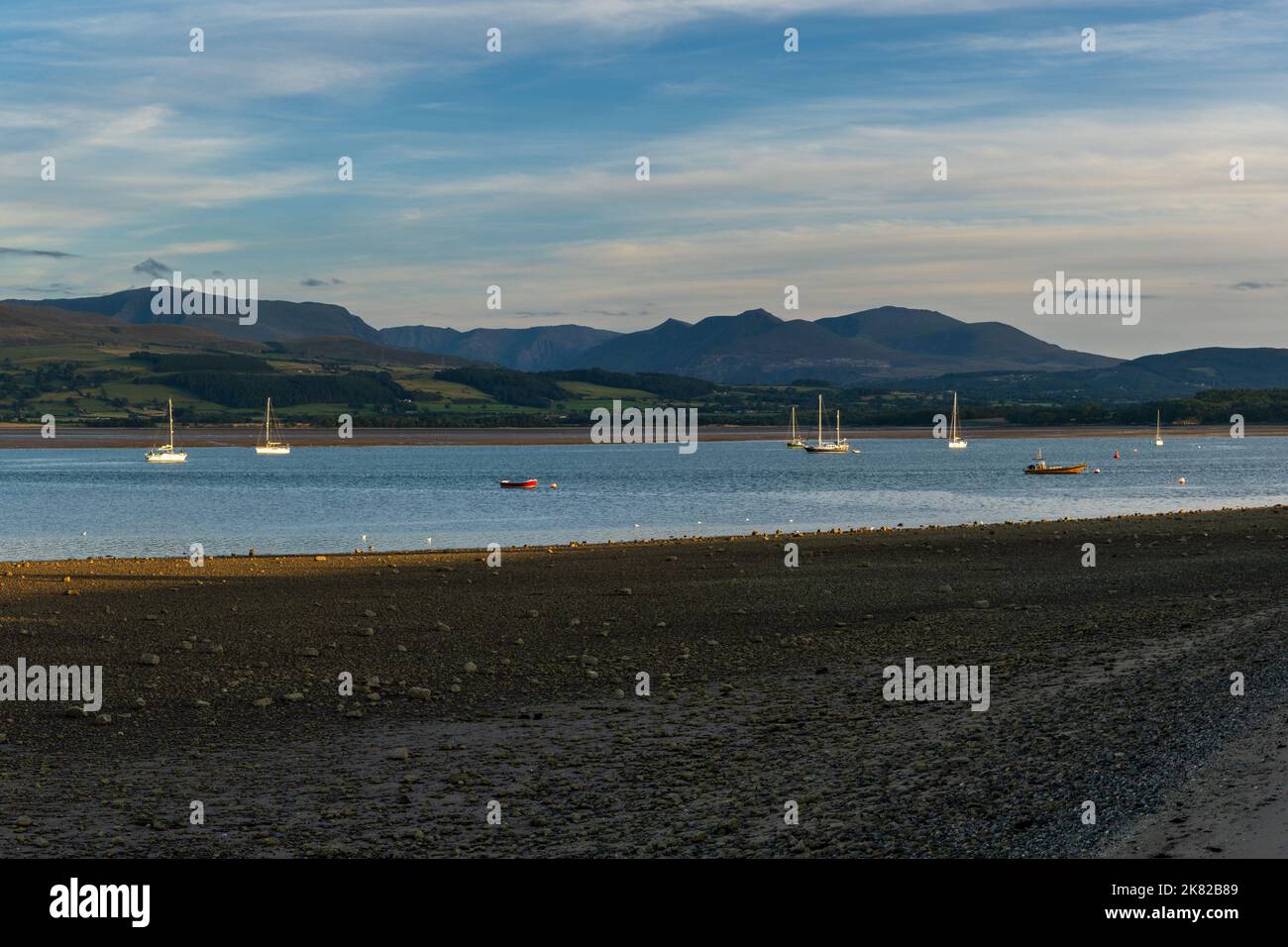 landscape view of the Menai Strait with many boats at anchor and the ...