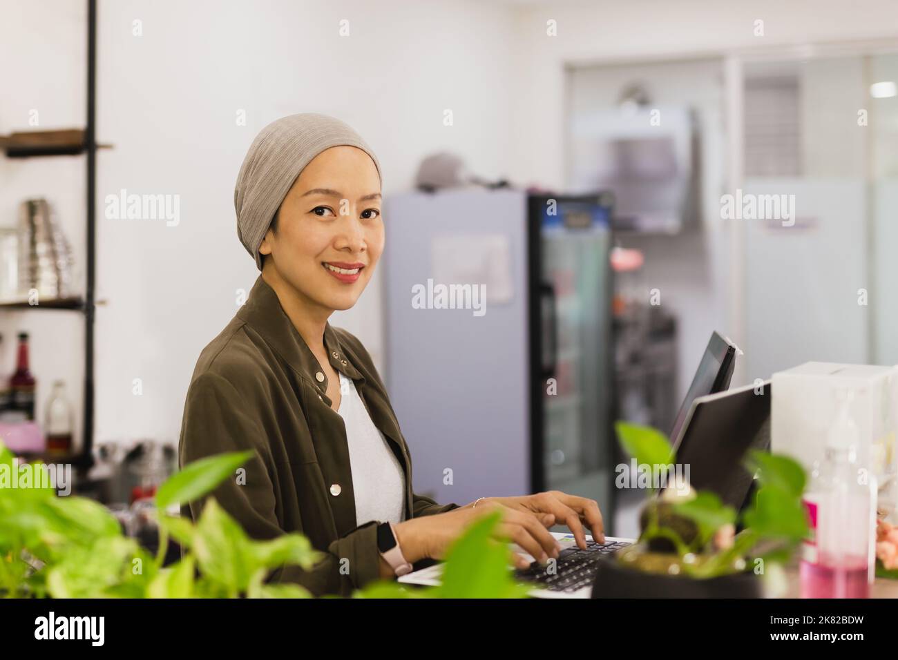Confident restaurant owner business woman standing behind the counter ...