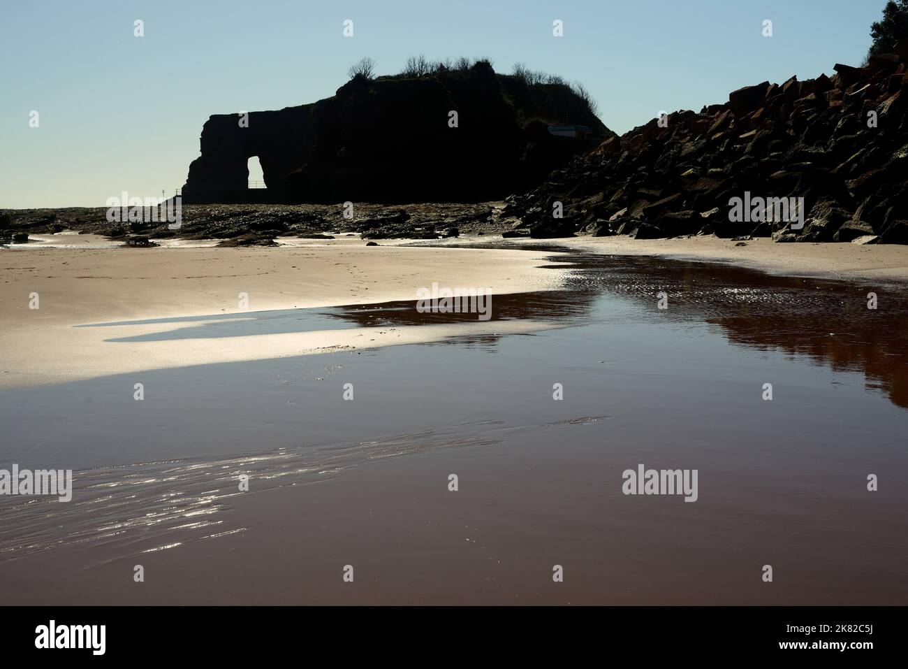 Silhouette of Langstone Rock at Dawlish Warren seen from the beach at ...