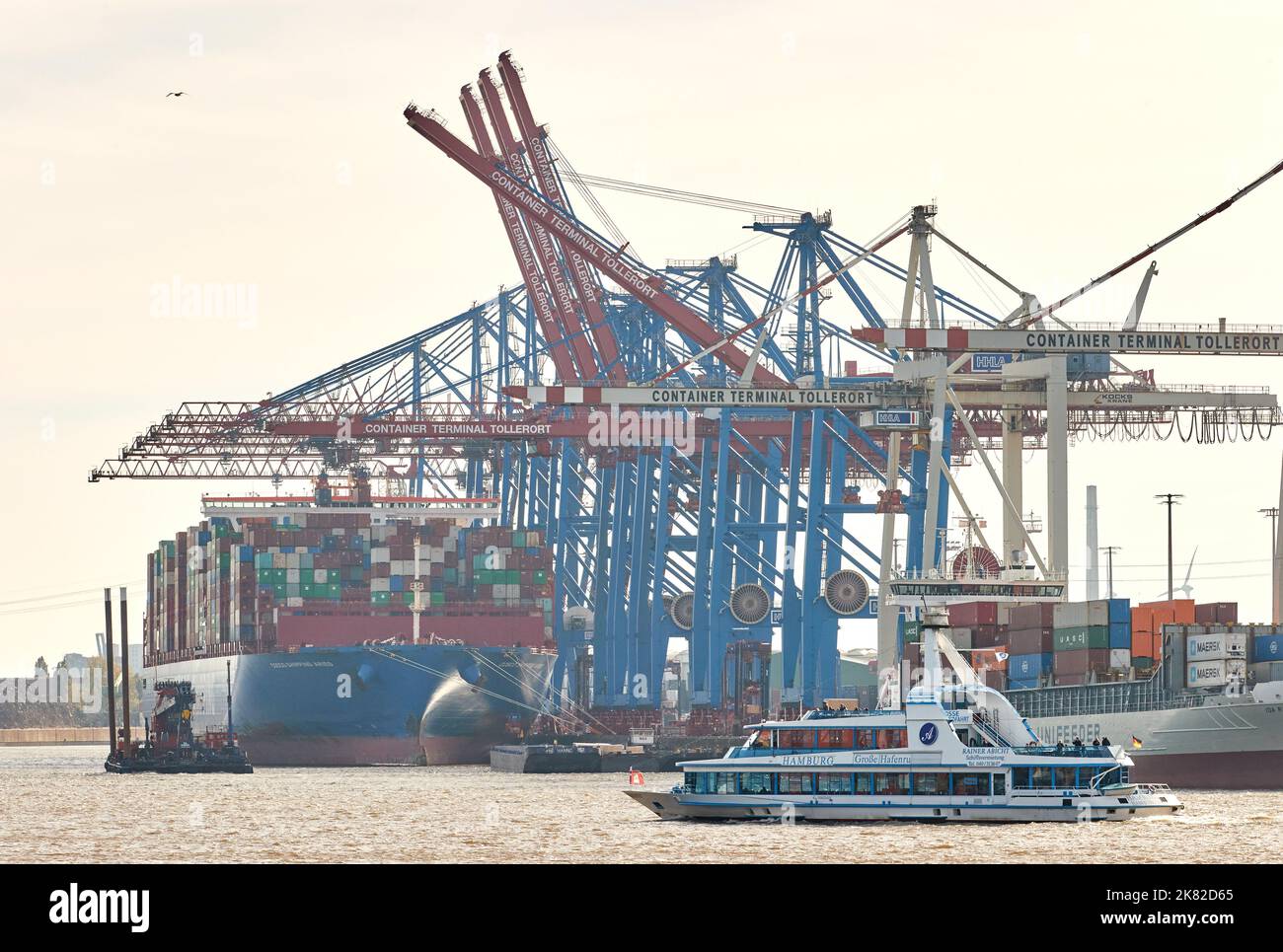 Hamburg, Germany. 20th Oct, 2022. A harbour cruise ship passes the cranes and container ships in ...
