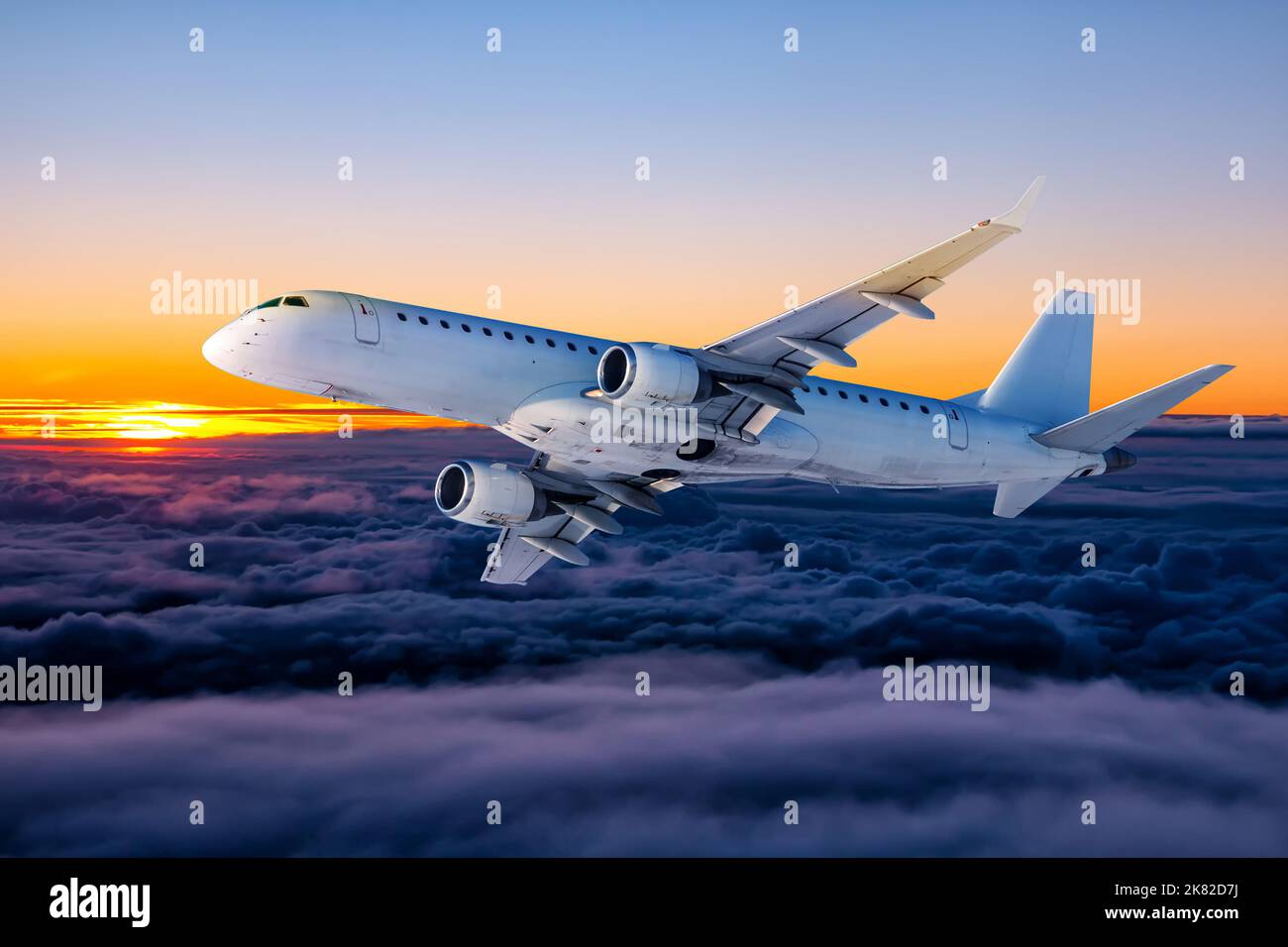 White passenger aircraft fly in the sunset sky Stock Photo - Alamy