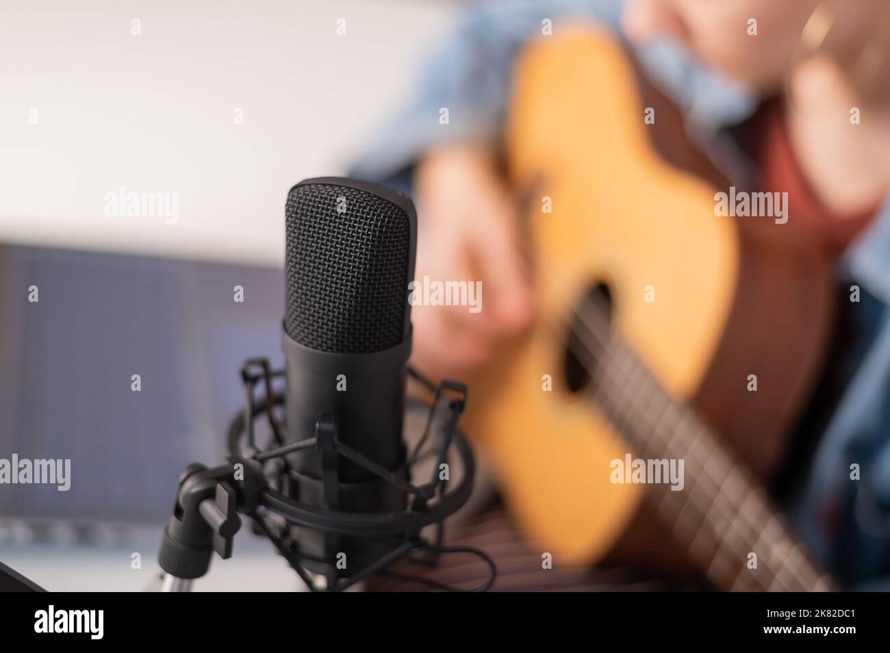 Faceless woman playing guitar and streaming live on laptop Stock Photo ...