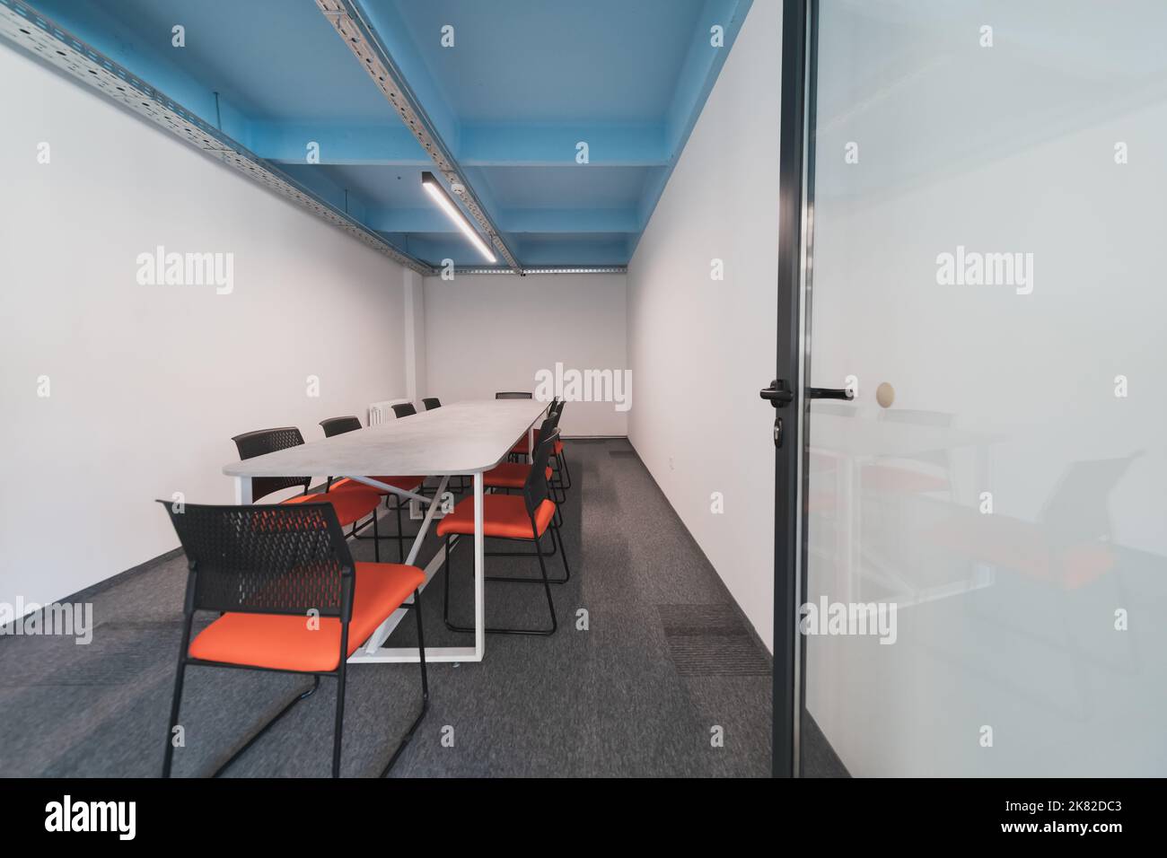 Interior of cozy light boardroom with table, modern stylish chairs and desktop computer, all ...