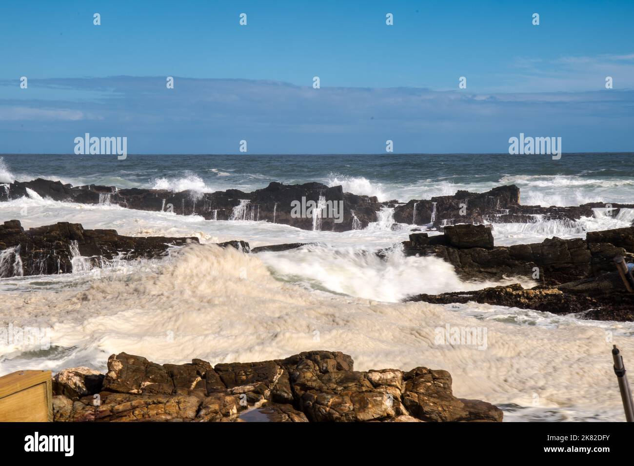 Foamy waves crash against rugged hi-res stock photography and images ...