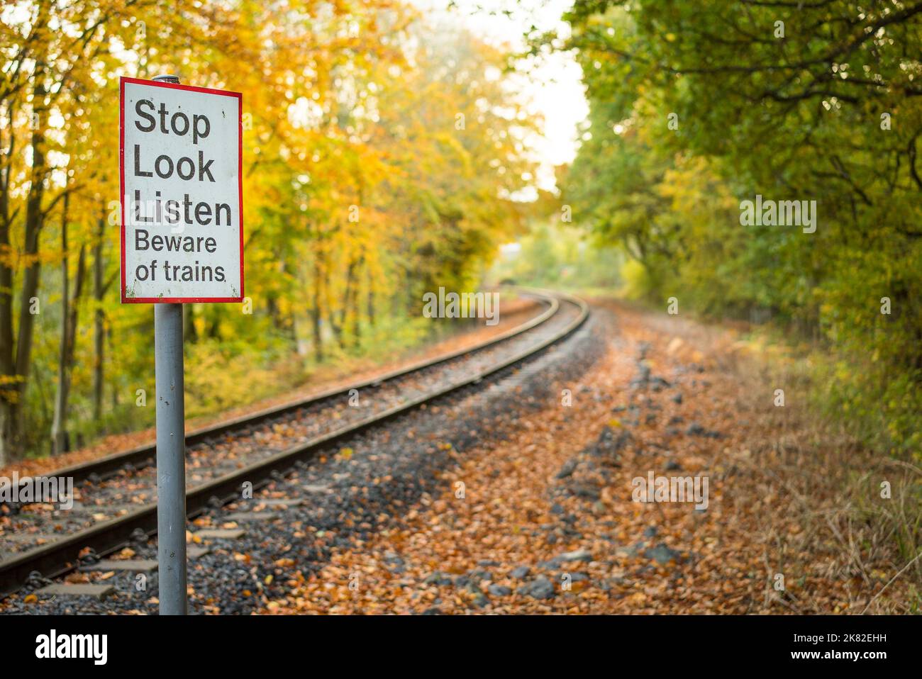 Stop, look, listen, beware of trains sign at a foot crossing over a ...