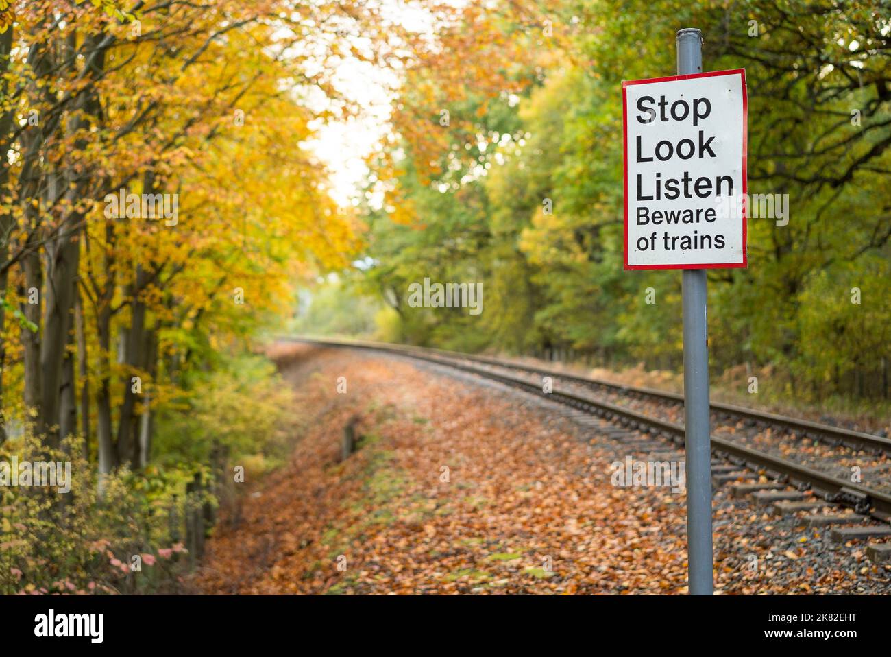 Stop, look, listen, beware of trains sign at a foot crossing over a ...