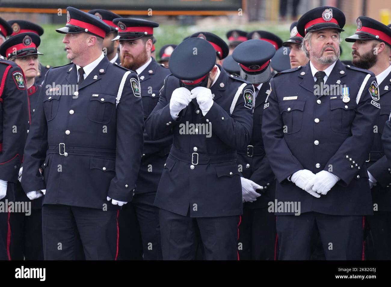 South Simcoe Police Service officers line up in a procession before the ...