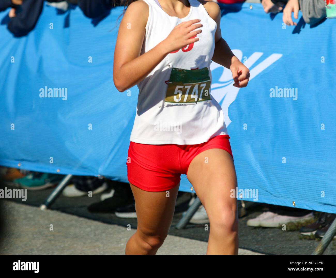 Close up of a female high school runner finishing a cross country race ...