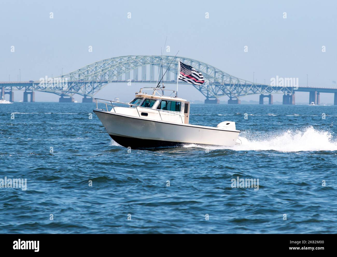 Motor boat with American Flag moving fast with the great south bay ...