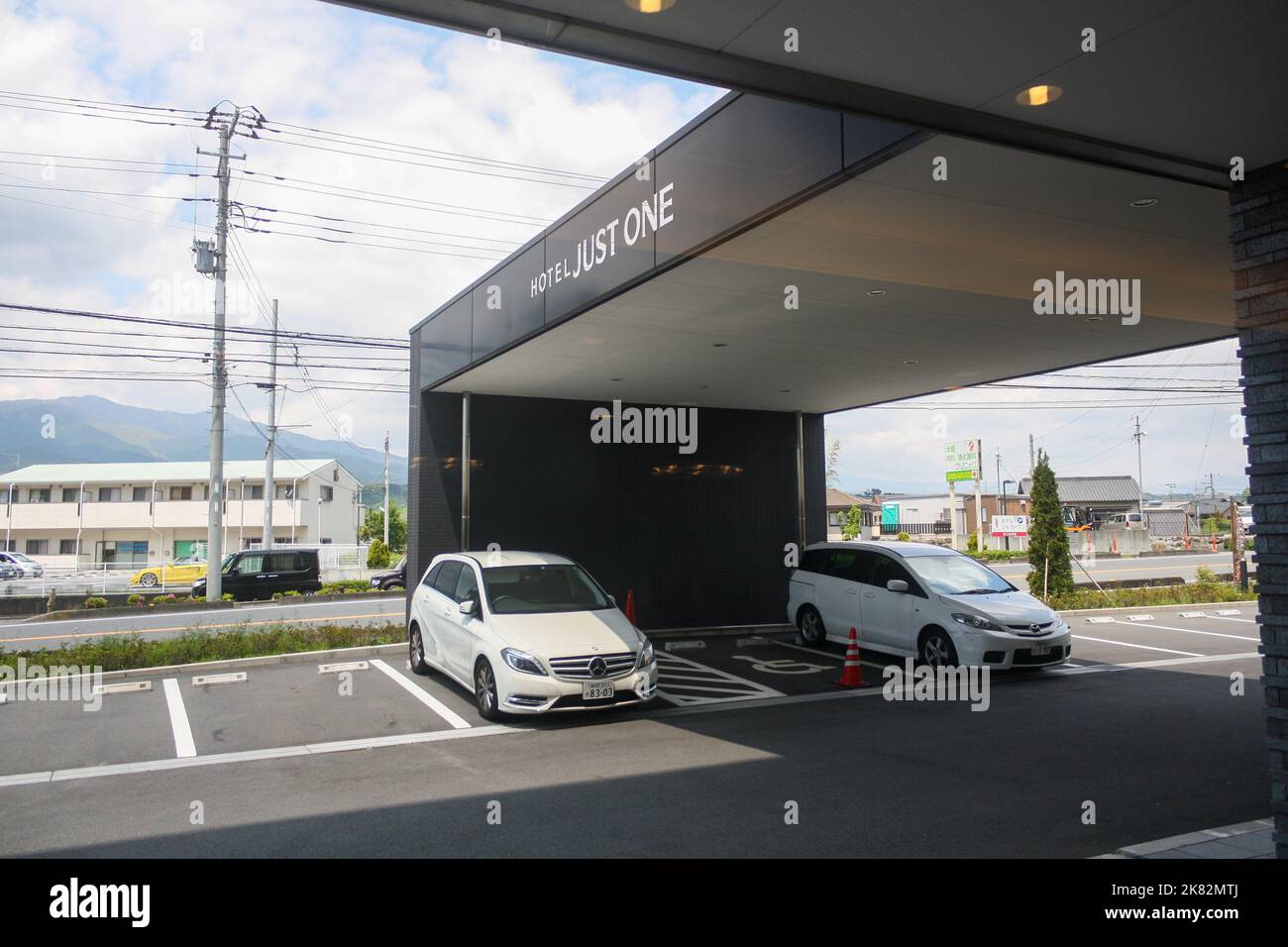 View of front exterior of Just One Hotel from lobby with signage and ...