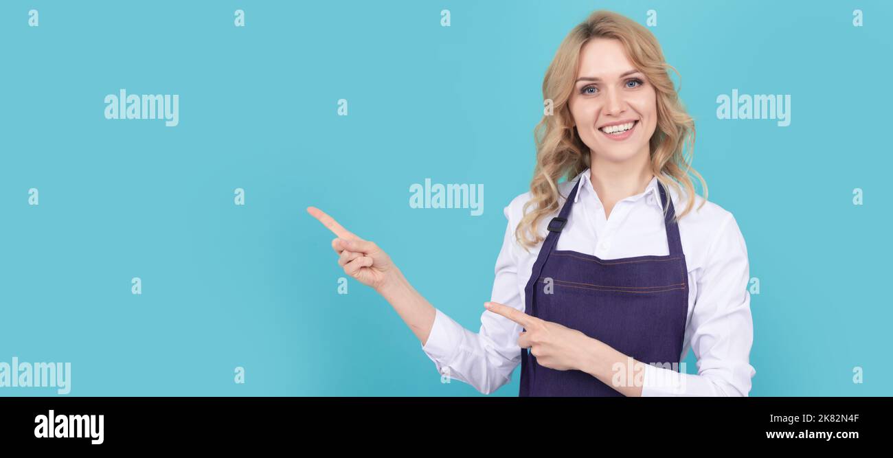 happy girl barista in cook apron pointing finger, advertisement. Woman ...