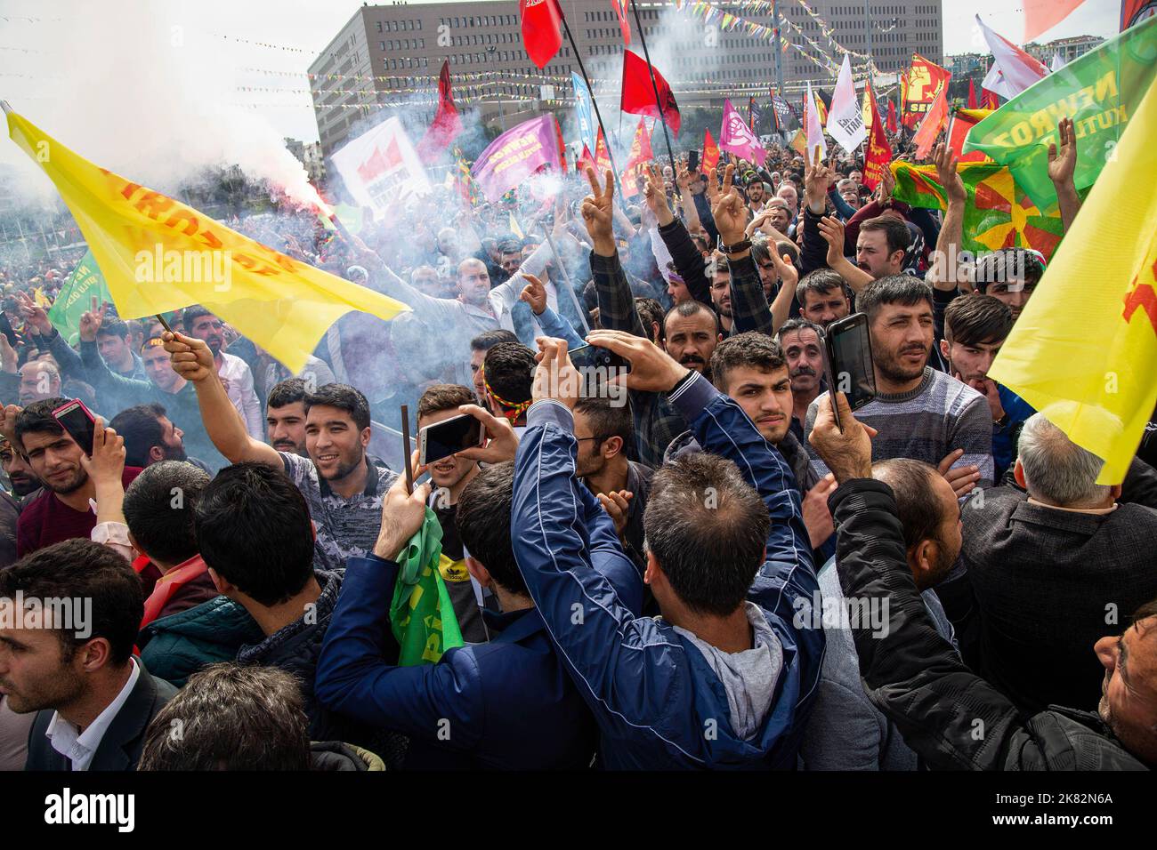 People chant slogans and hold smoke flares during the celebration of ...