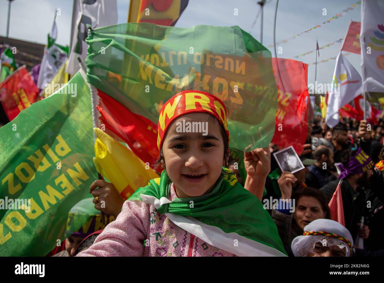 A child is seen with a head band and draped with a flag during the ...