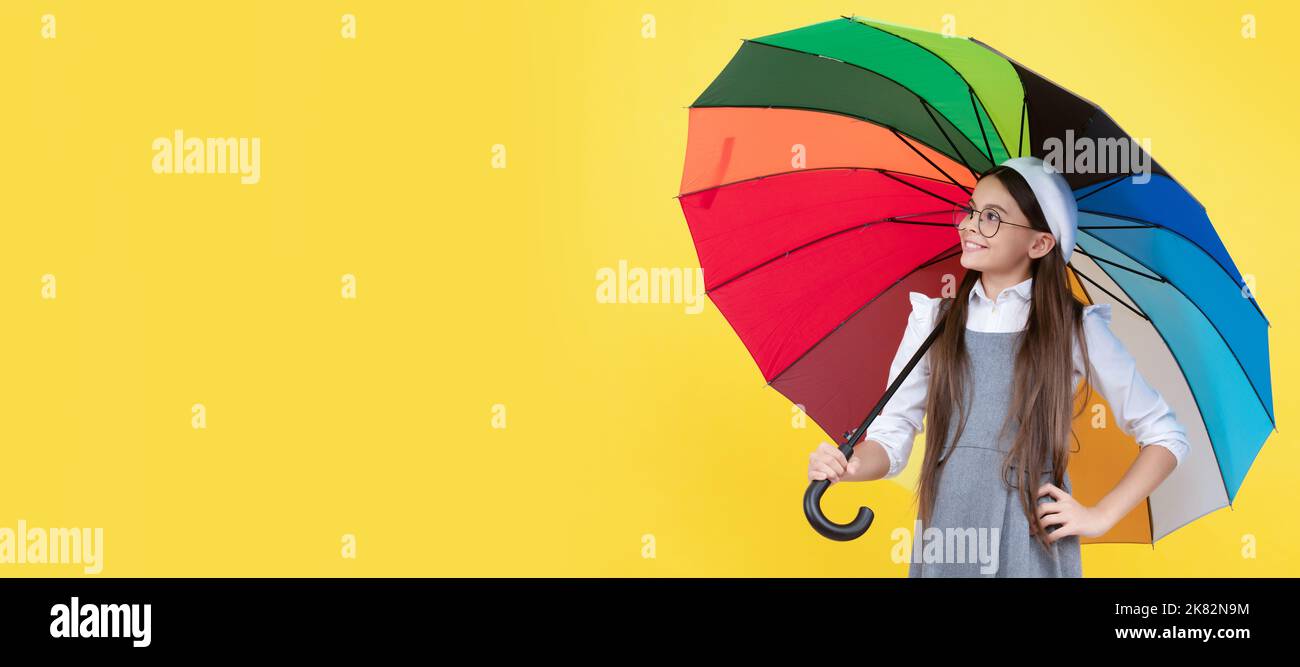 happy teen girl under colorful umbrella for rain protection in autumn ...