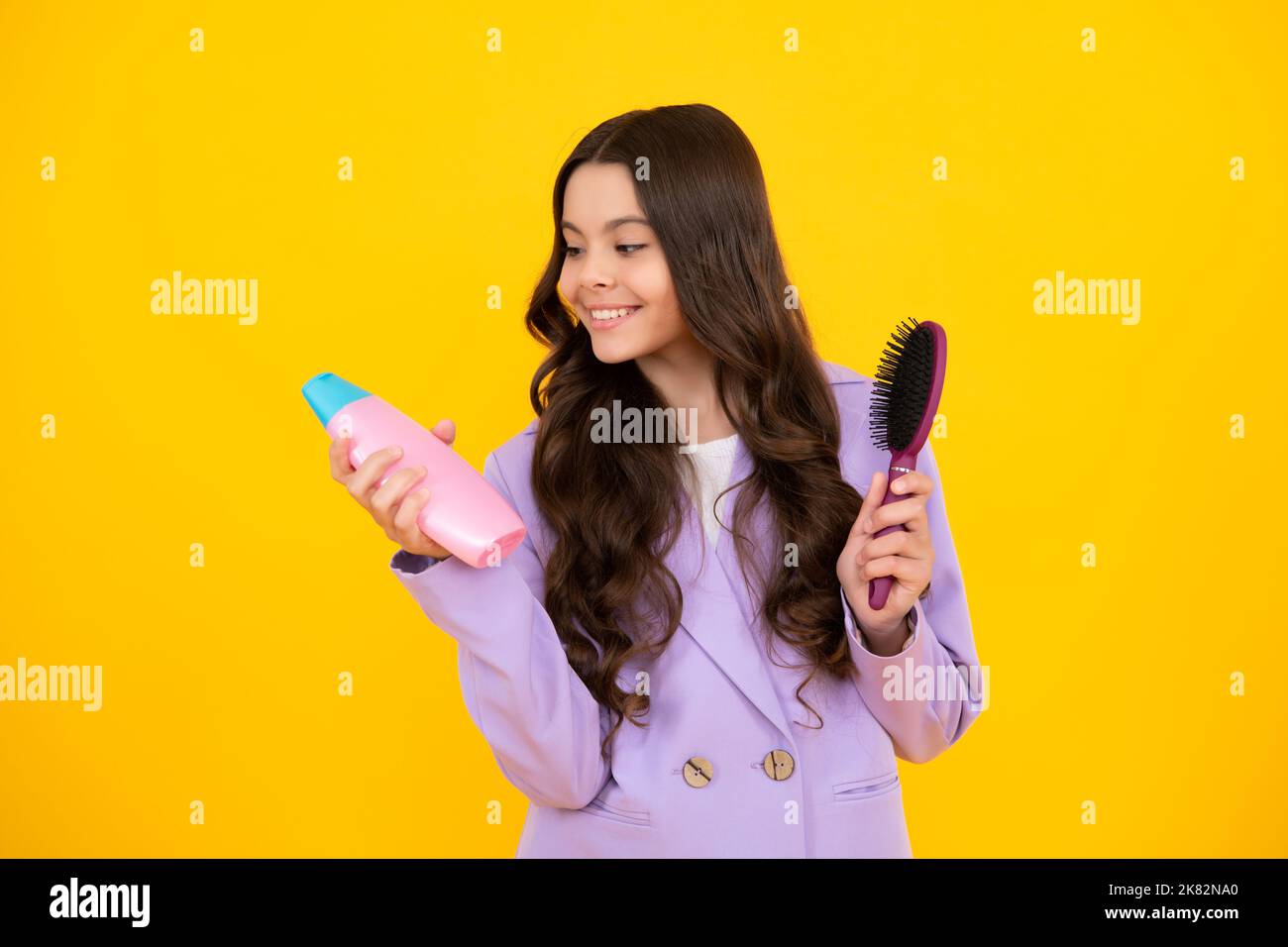 Child teen girl with shampoos conditioners and shower gel. Long hair ...