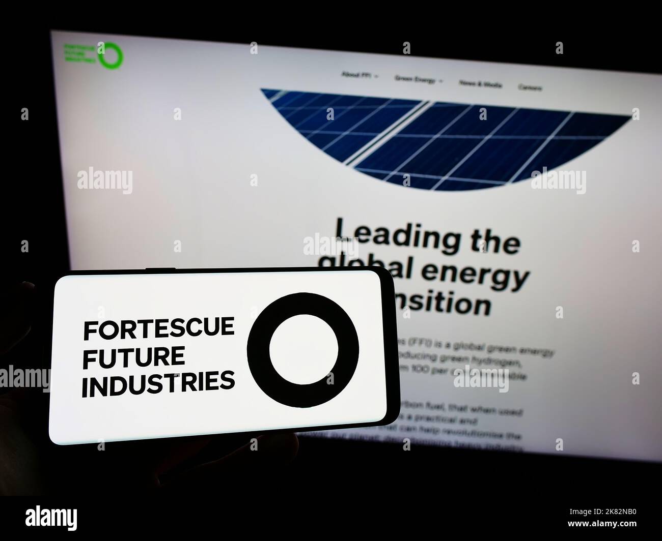 Person holding cellphone with logo of energy company Fortescue Future ...