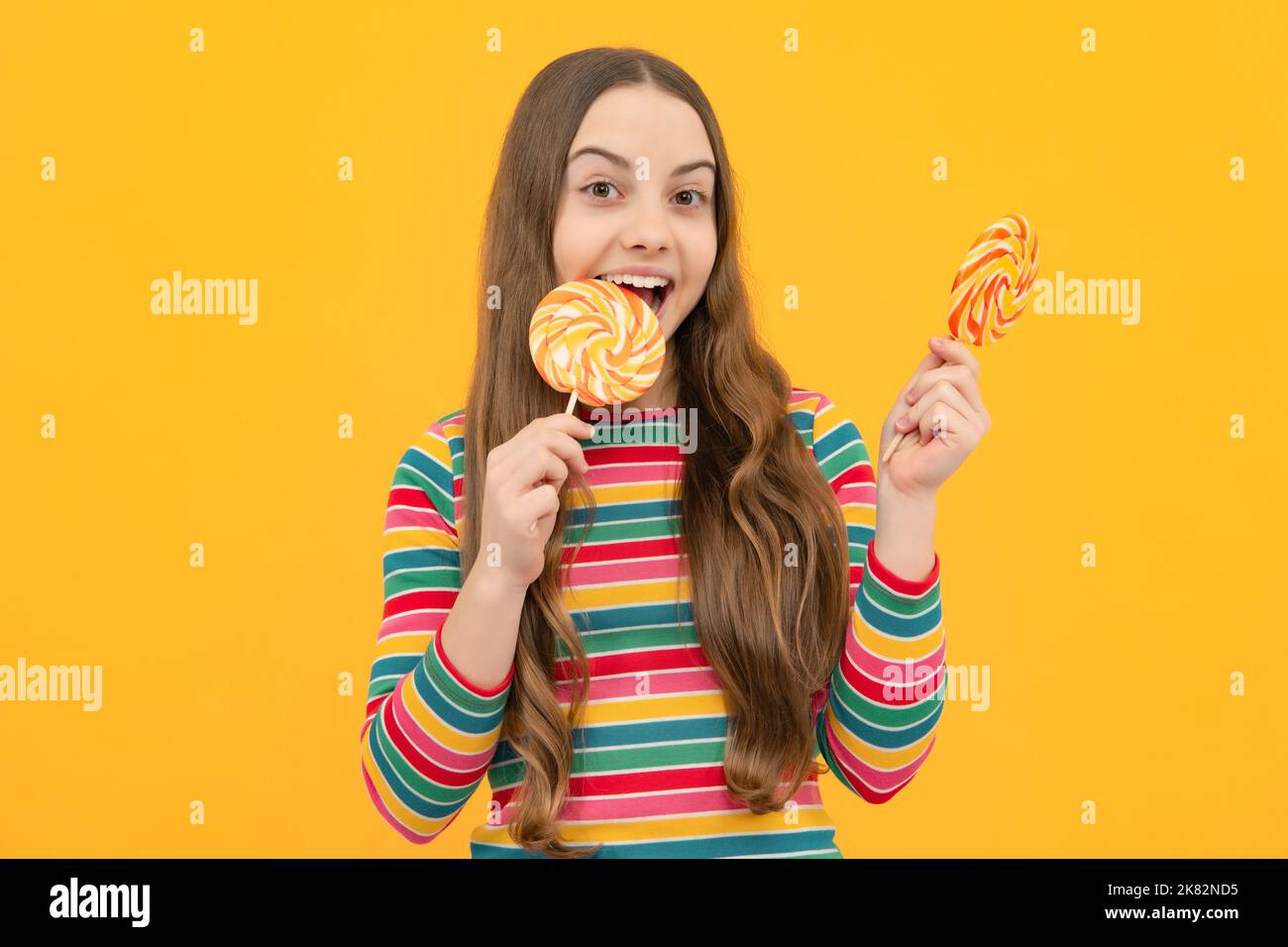 Teenager girl with caramel candies on sticks, sweet sugar addiction ...
