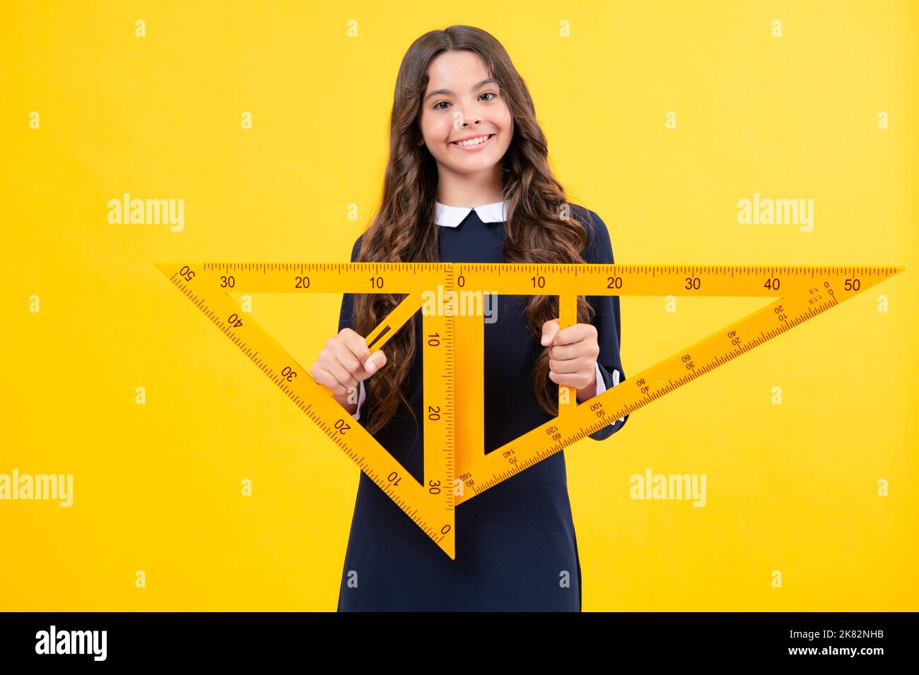 Measuring school equipment. Schoolgirl holding measure for geometry ...