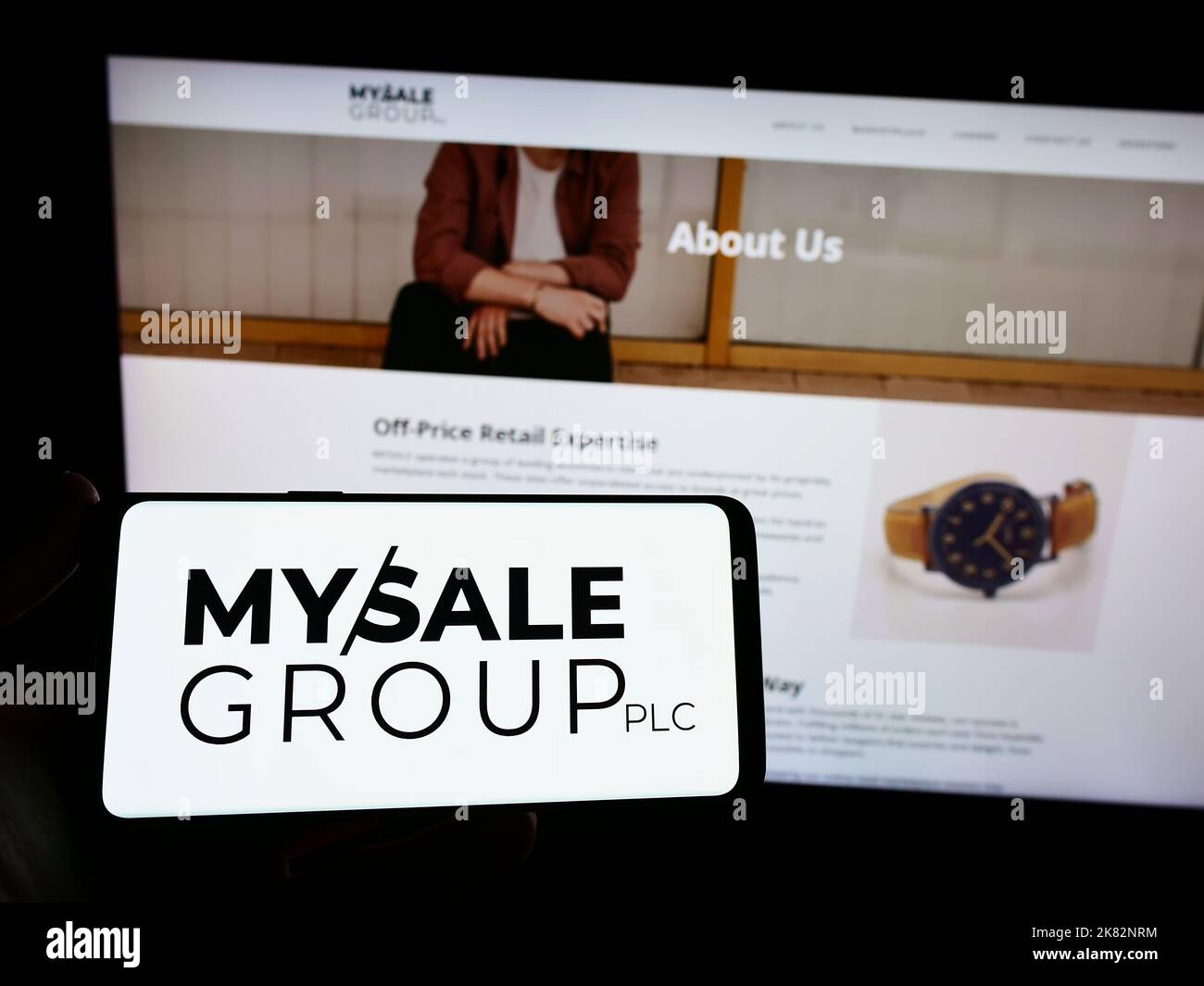 Person holding smartphone with logo of Australian e-commerce company ...