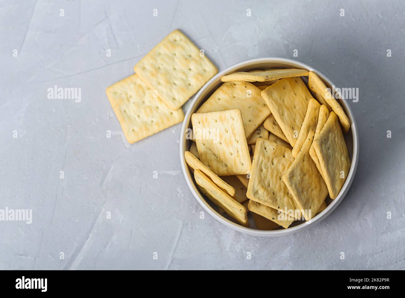Bowl of dry crackers isolated on gray background with shadow, flat lay ...