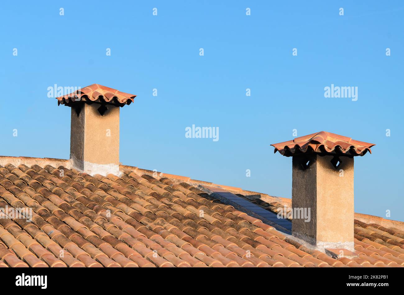 Mediterranean chimneys on roof with clay tiles in front of sky Stock ...