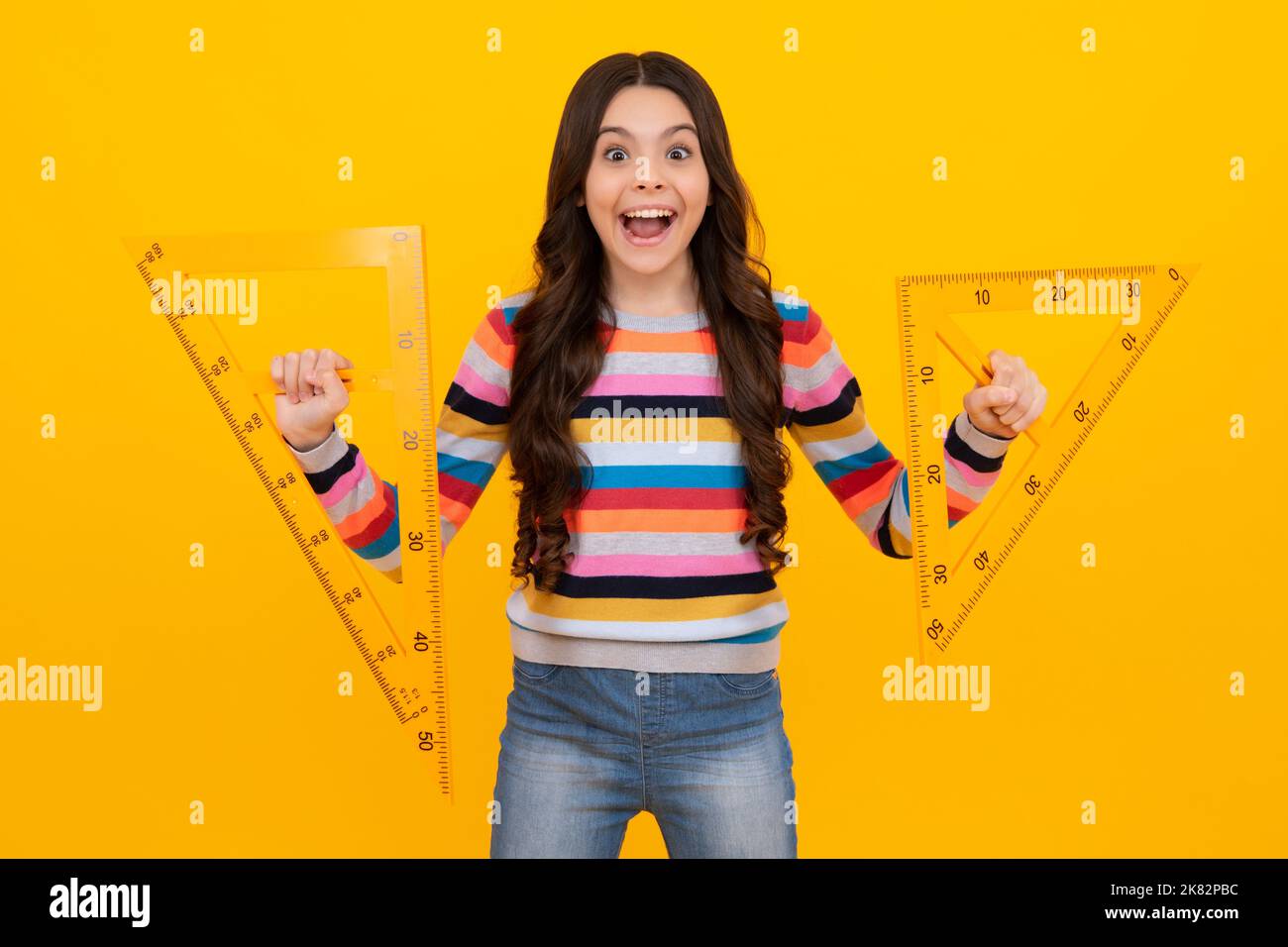 Amazed teenager. Teenager school girl study math or geometry lesson ...