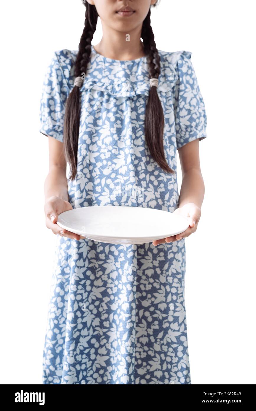 A girl is holding an empty plate in her hands on a white background ...
