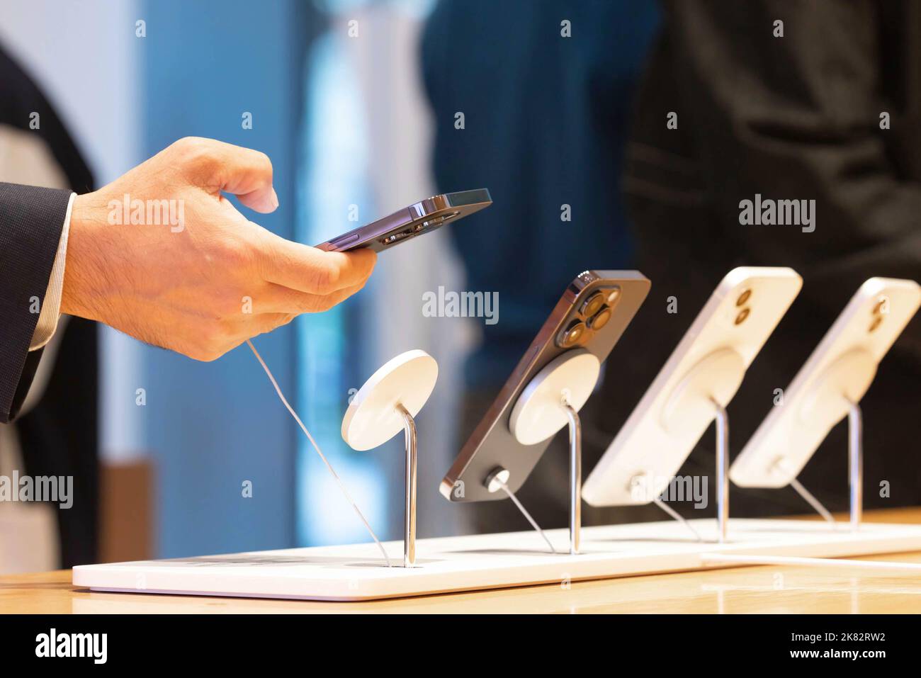 Customer interacts with iPhone 14 Pro Max inside Apple store in ...