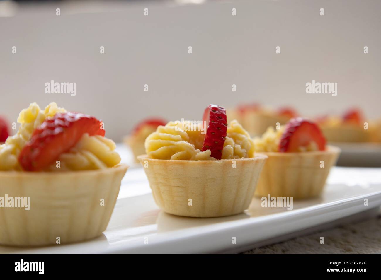 appetizing cupcakes with pastry cream and strawberry, delicious sweet ...