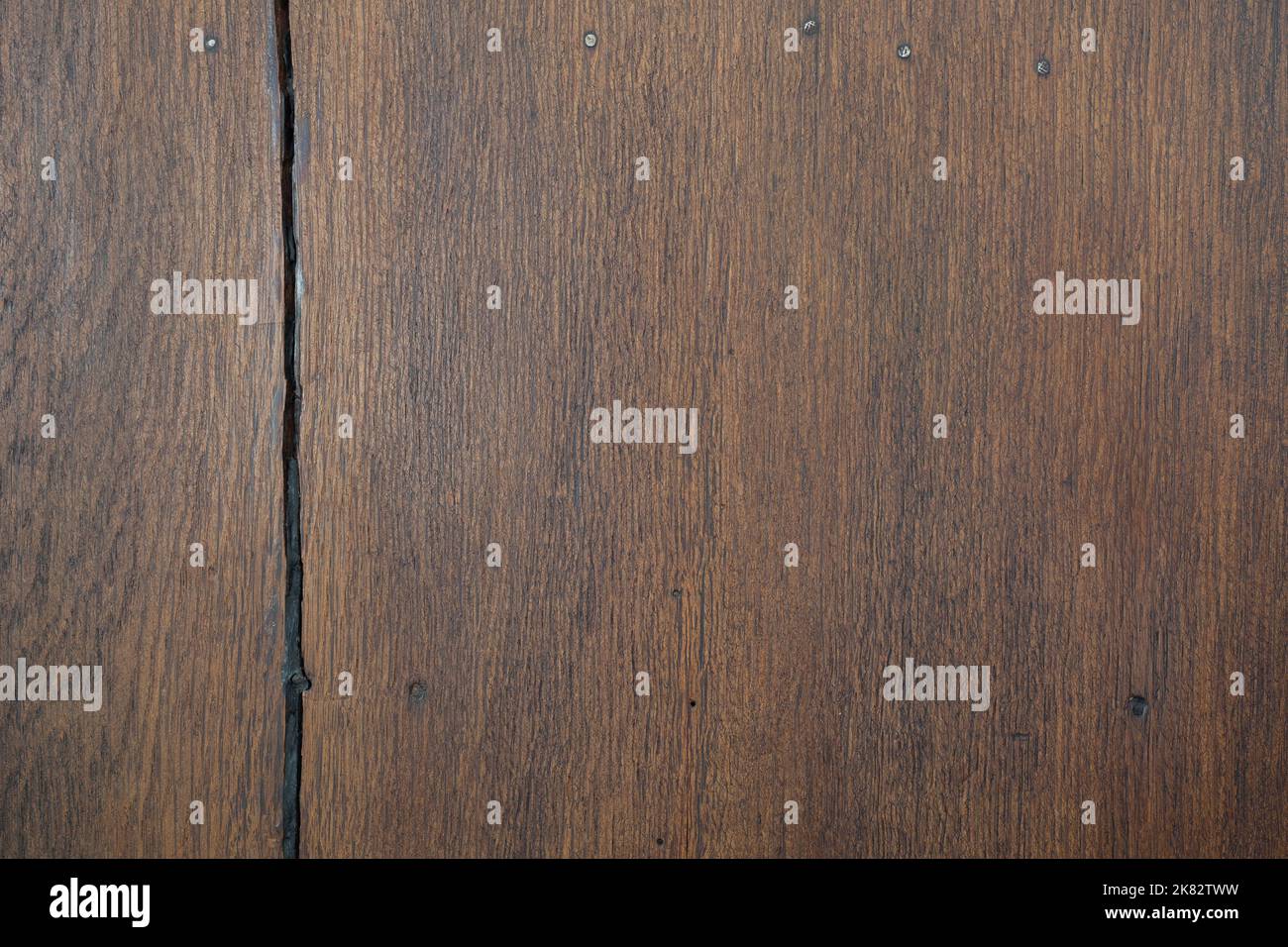 Closeup of a wooden side panel of an antique empire commode cabinet ...