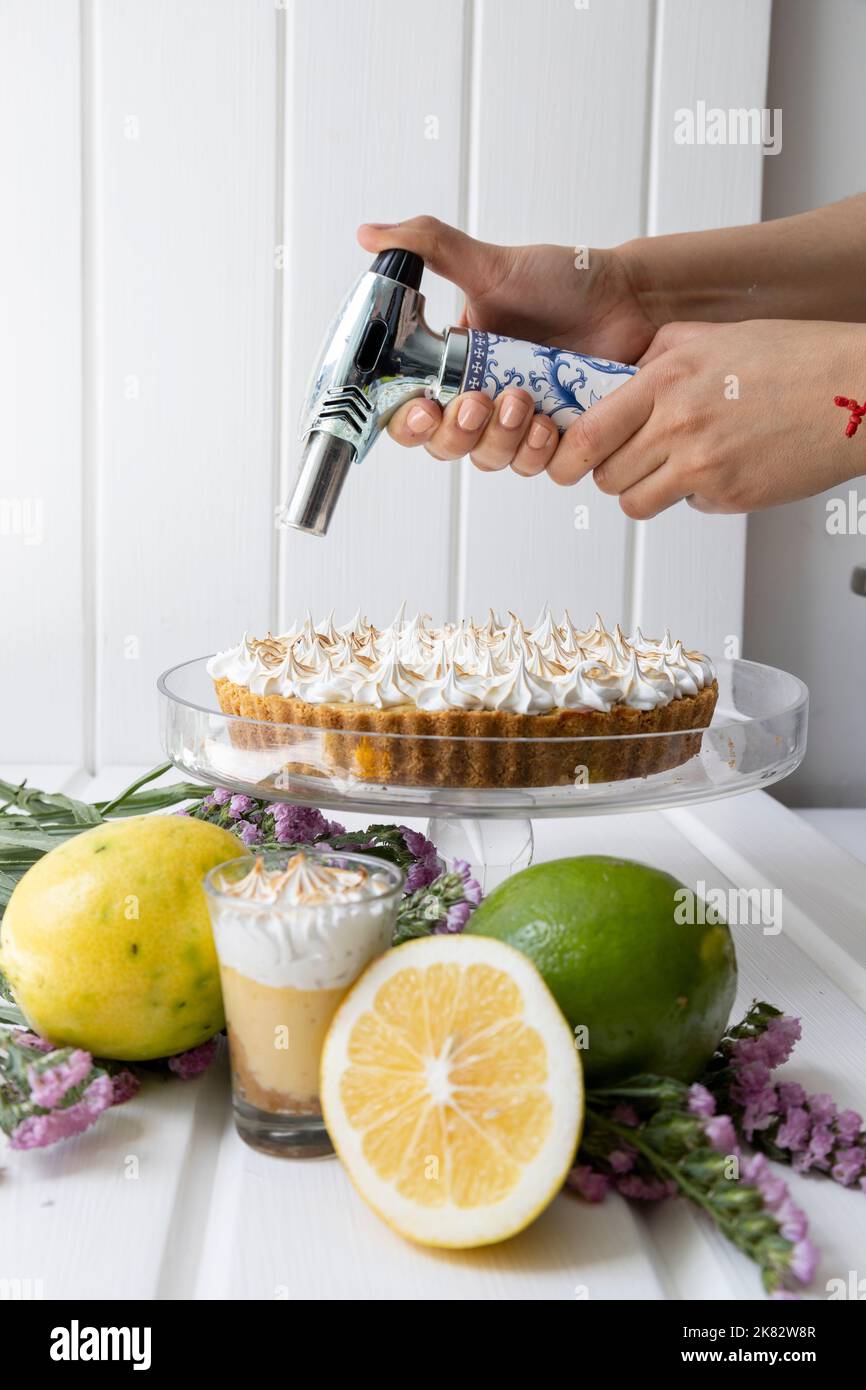 table with fruits as decoration, cup with coffee and a cake with cream ...