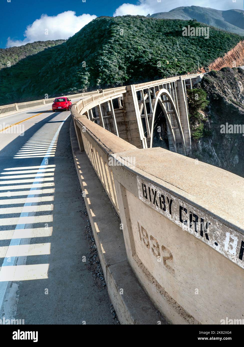 Bixby Creek Bridge with red car crossing at Big Sur Monterey California ...