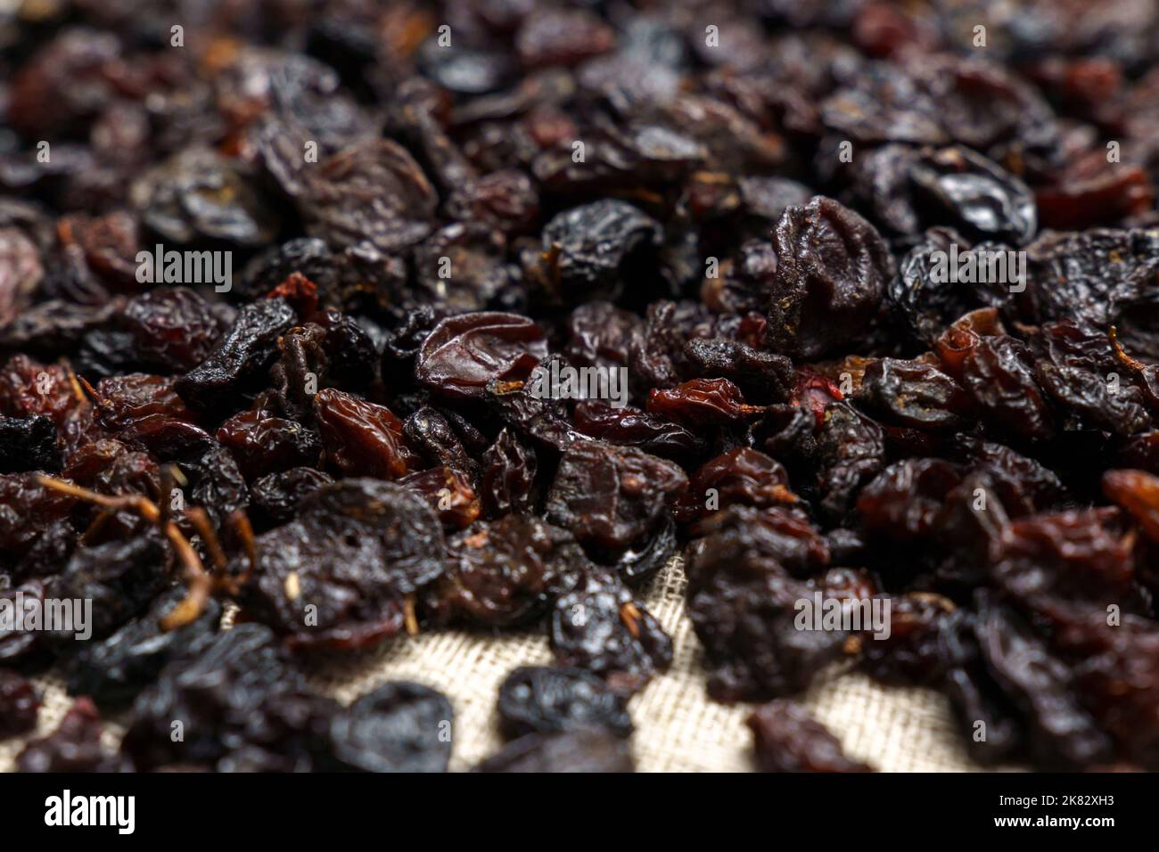 Dried black raisins. Raisins are obtained by dehydrating fresh grapes ...