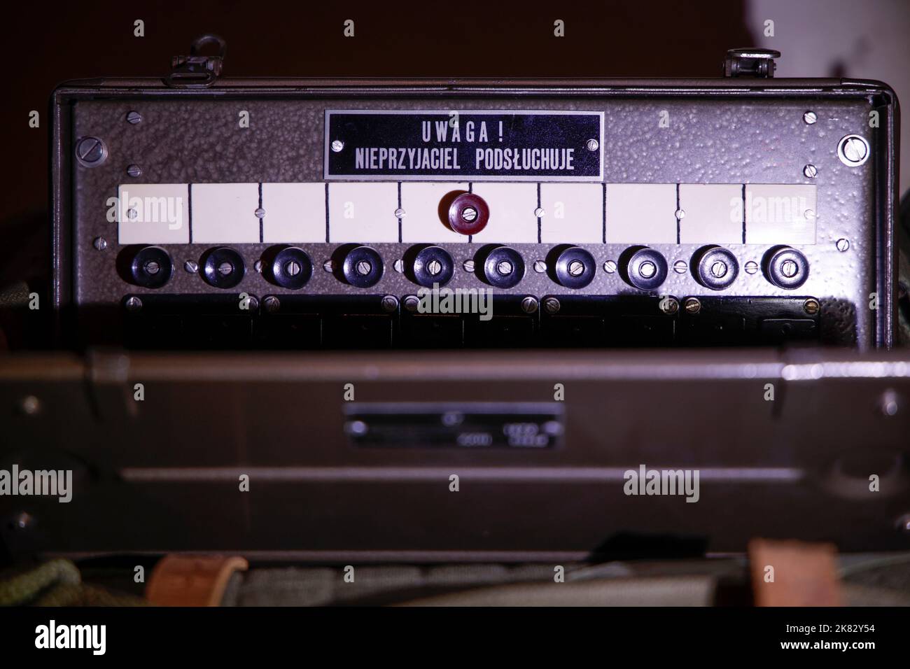 A communication device is seen with a plate with the words 'Warning ...