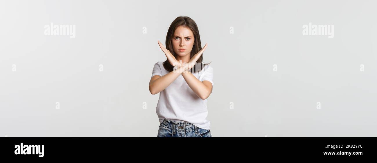 Serious angry woman showing cross, stop something bad, express ...