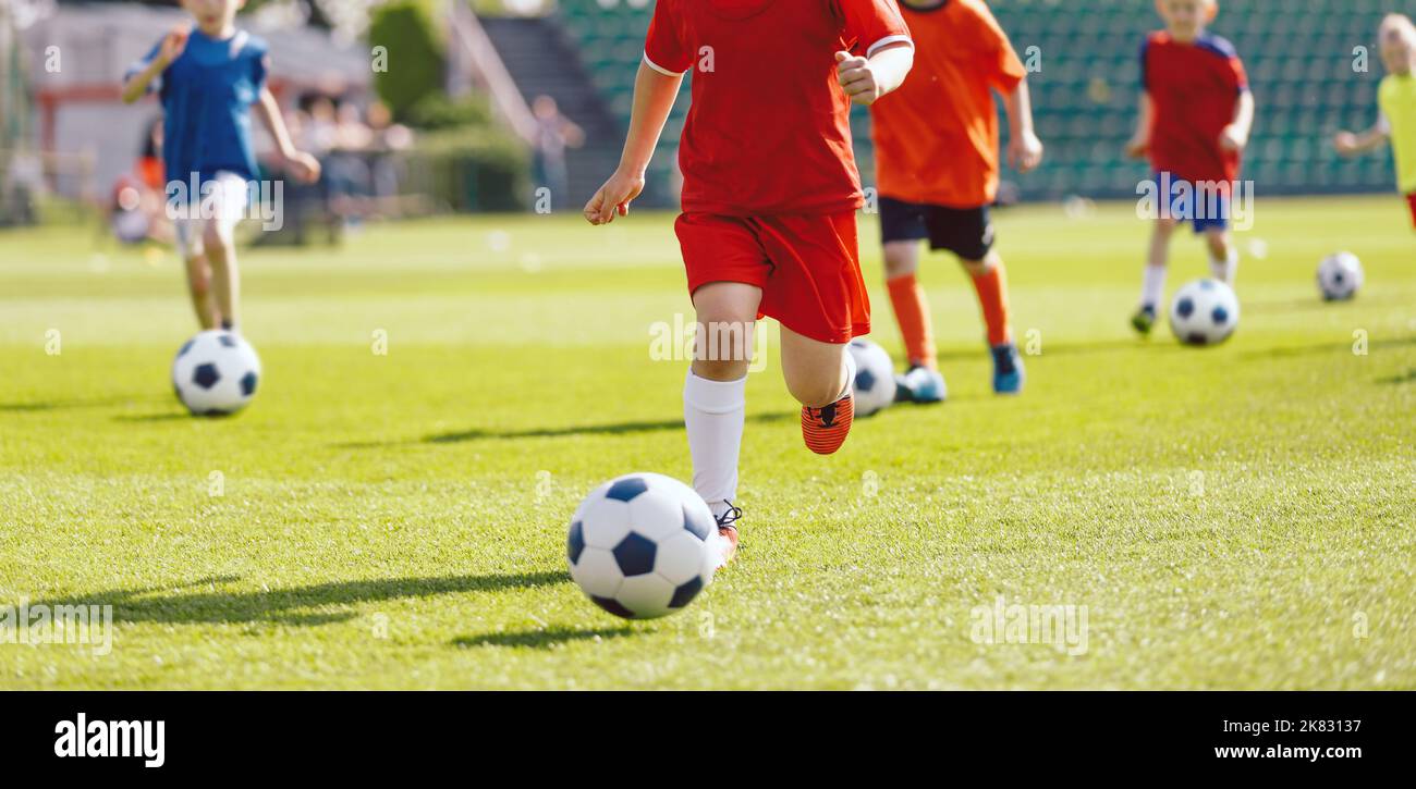 Kids Soccer Training Camp. Kids practicing football on grass field ...