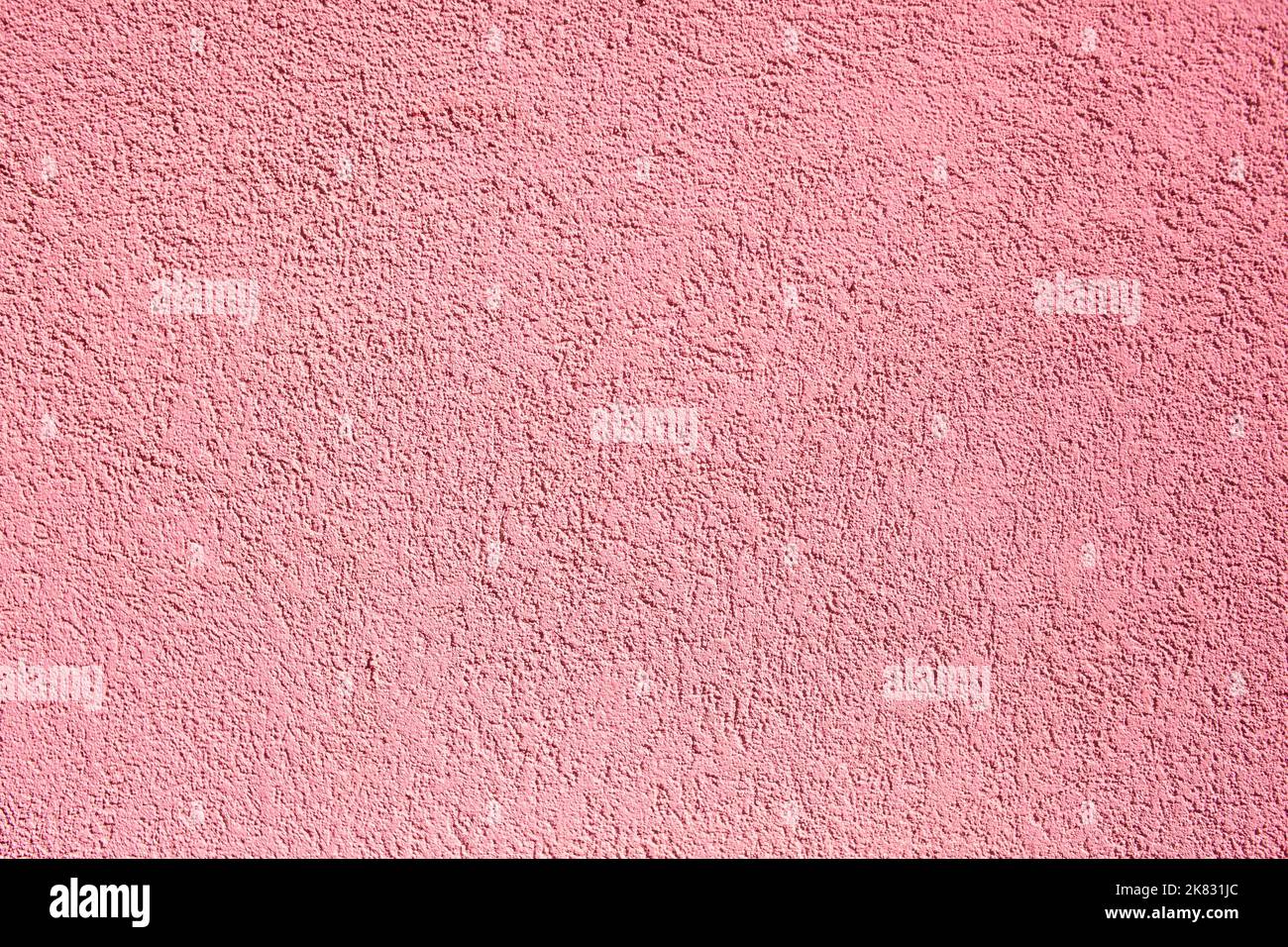 Background of pink concrete wall. Decorative embossed concrete and glue ...
