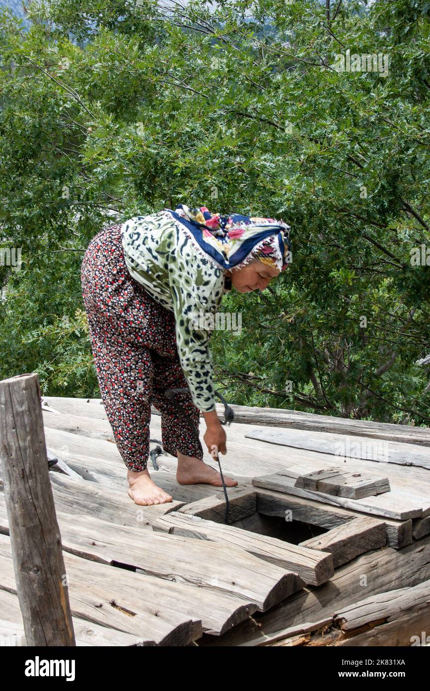 A Turkish woman draws water from a well in the Taurus Mountains of ...