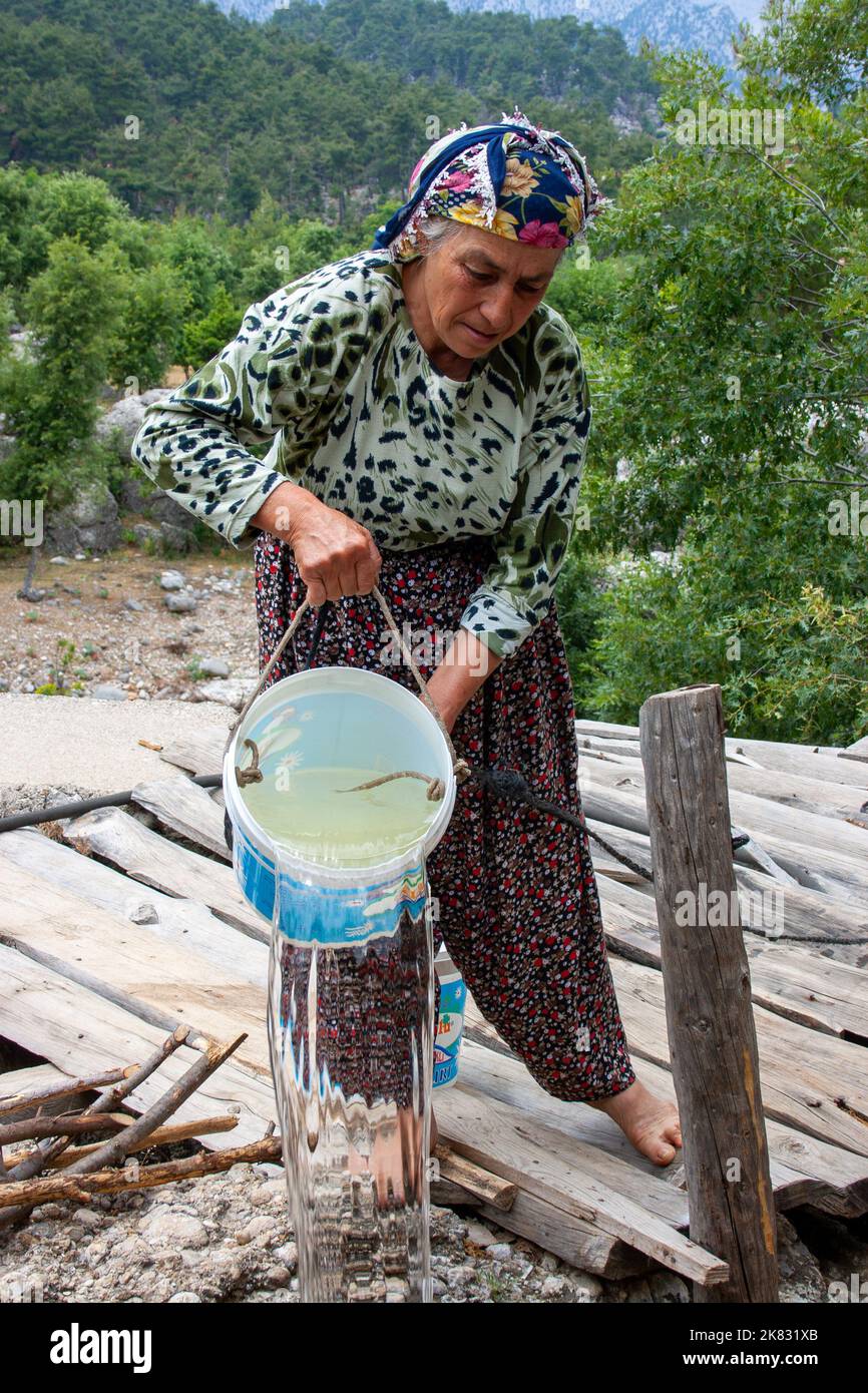 A Turkish woman draws water from a well in the Taurus Mountains of ...