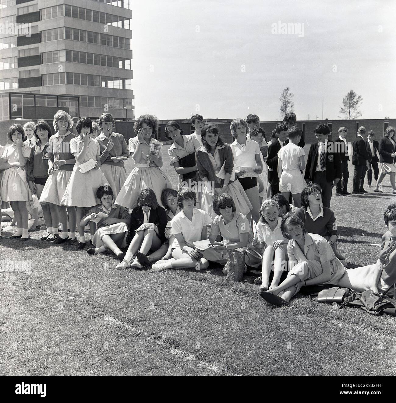 1960s, historical, technical school pupils outsode, wathcing sports day ...
