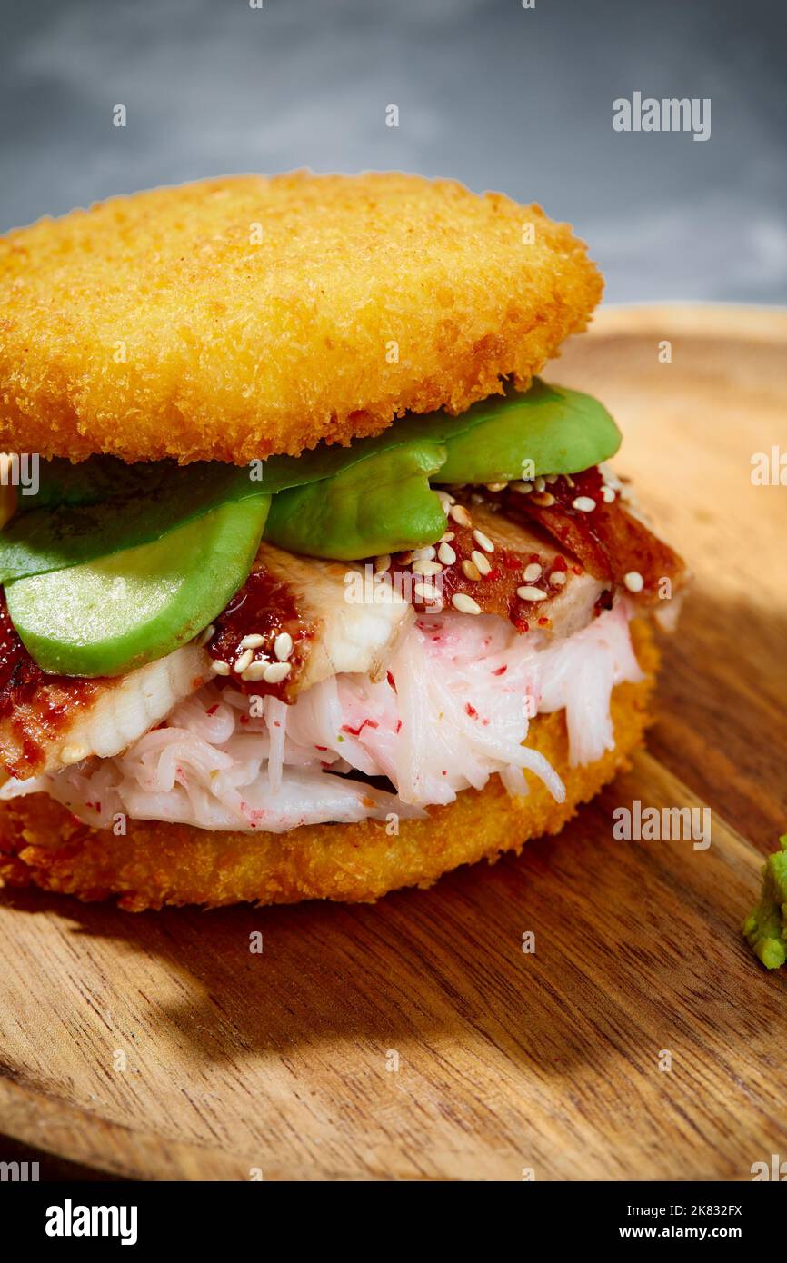 Pan-Asian cuisine concept. Japanese sushi burger made from rice bread ...