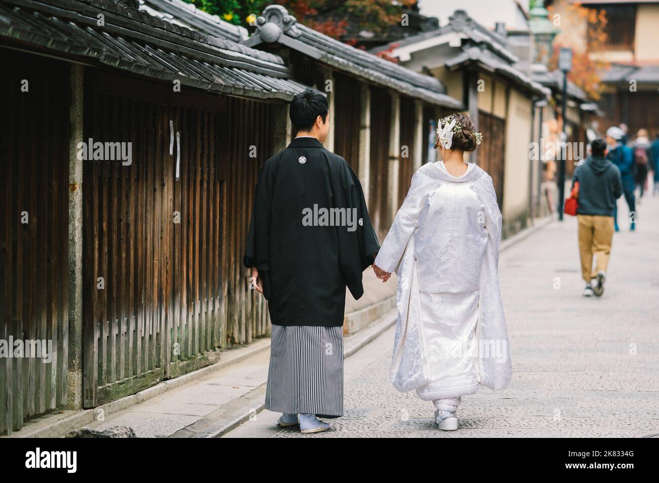A japanese couple on their wedding day dressed up in traditional kimono ...